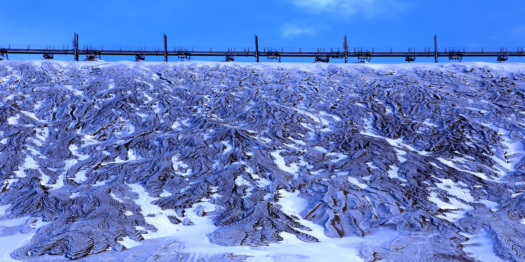 A snow-covered landscape with a unique pattern of undulating ridges ...